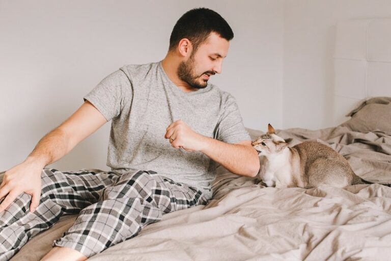 Why Does My Cat Grab & Bite My Arm? 6 Vet-Reviewed Reasons & What to Do ...